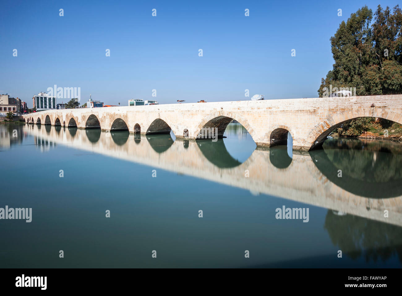 Ancient Roman bridge reflected in the tranquil water of the Seyhan ...