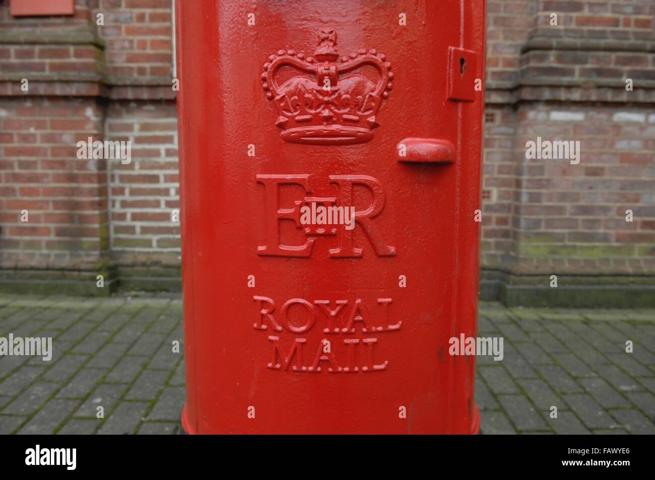 A red old fashioned letter box with a brick wall background Stock Photo ...