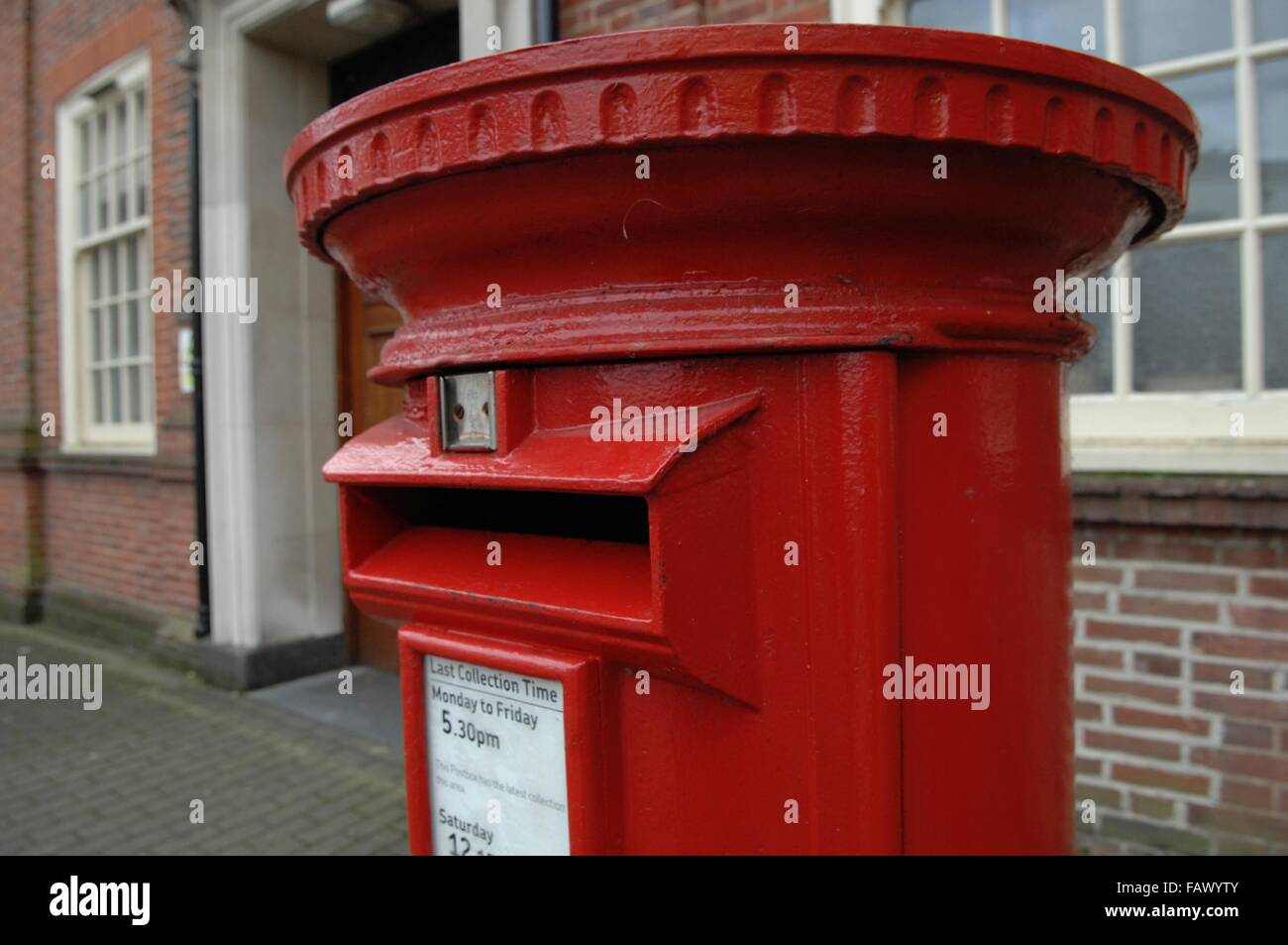 A red old fashioned letter box with a brick wall background Stock Photo ...