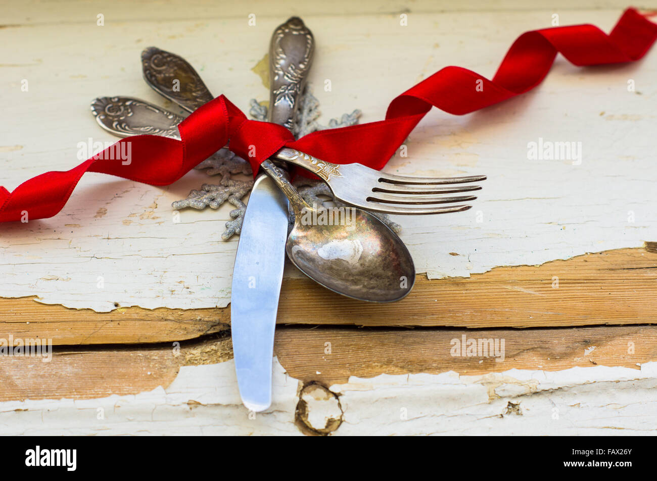 Vintage silverware with red ribbon on rustic background Stock Photo - Alamy