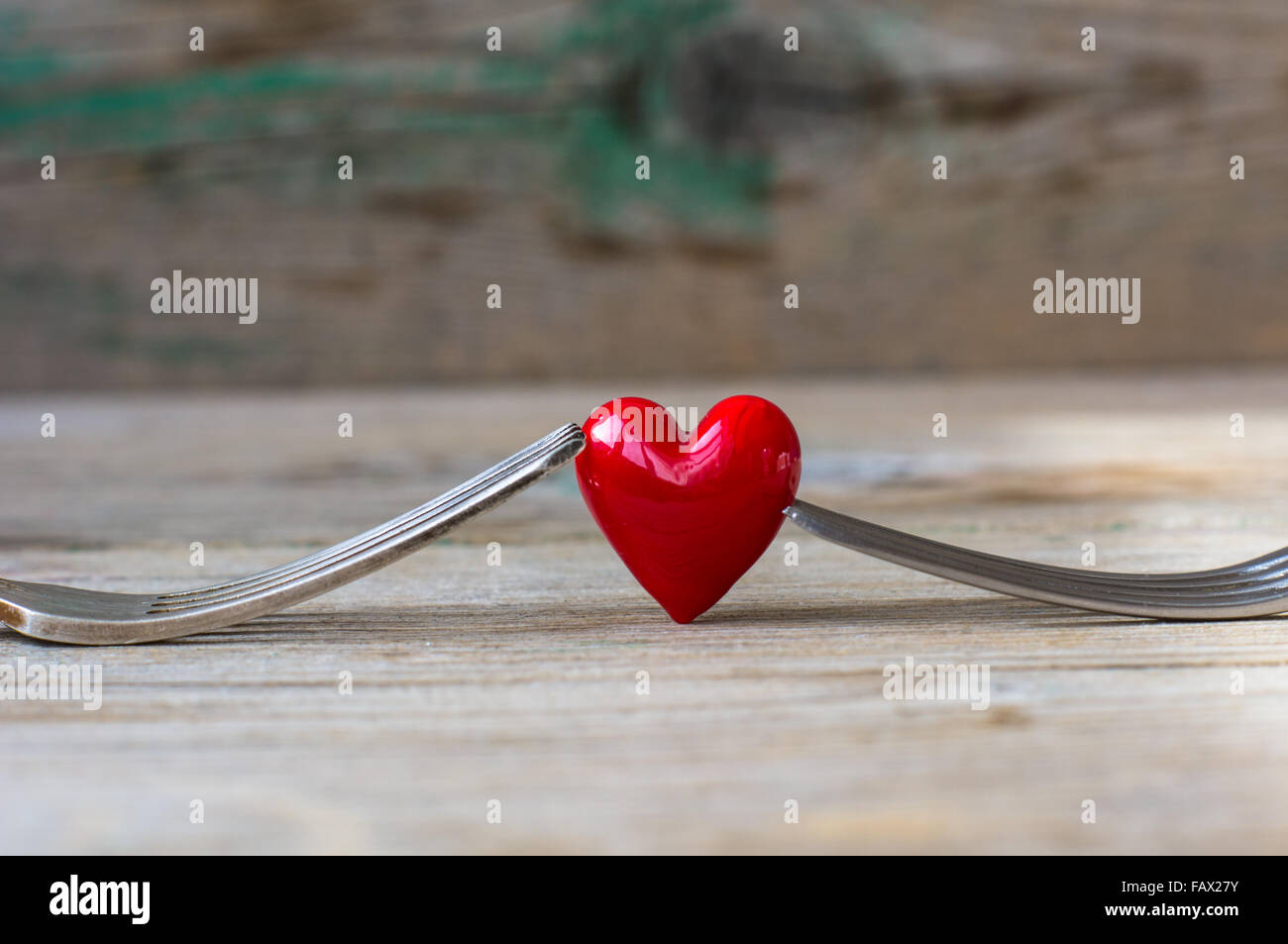 Red heart between two vintage forks on rustic wooden background Stock ...