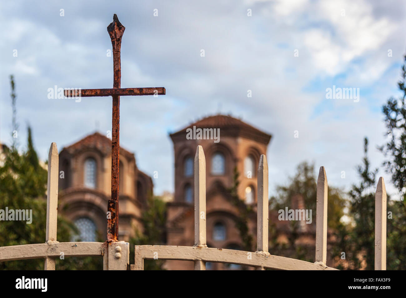 A rusty cross on a gate in front of a church; Thessaloniki, Greece ...