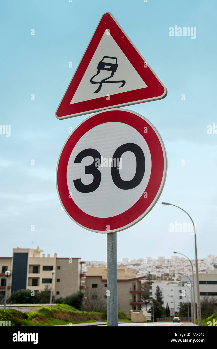 30 KPH road sign and danger of car skidding on road Stock Photo - Alamy