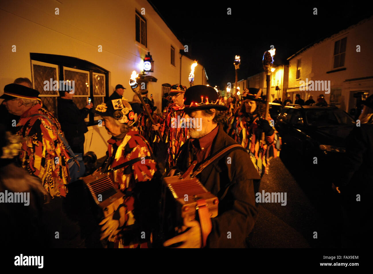 Members of the Sompting Village Morris carry flaming torches through ...
