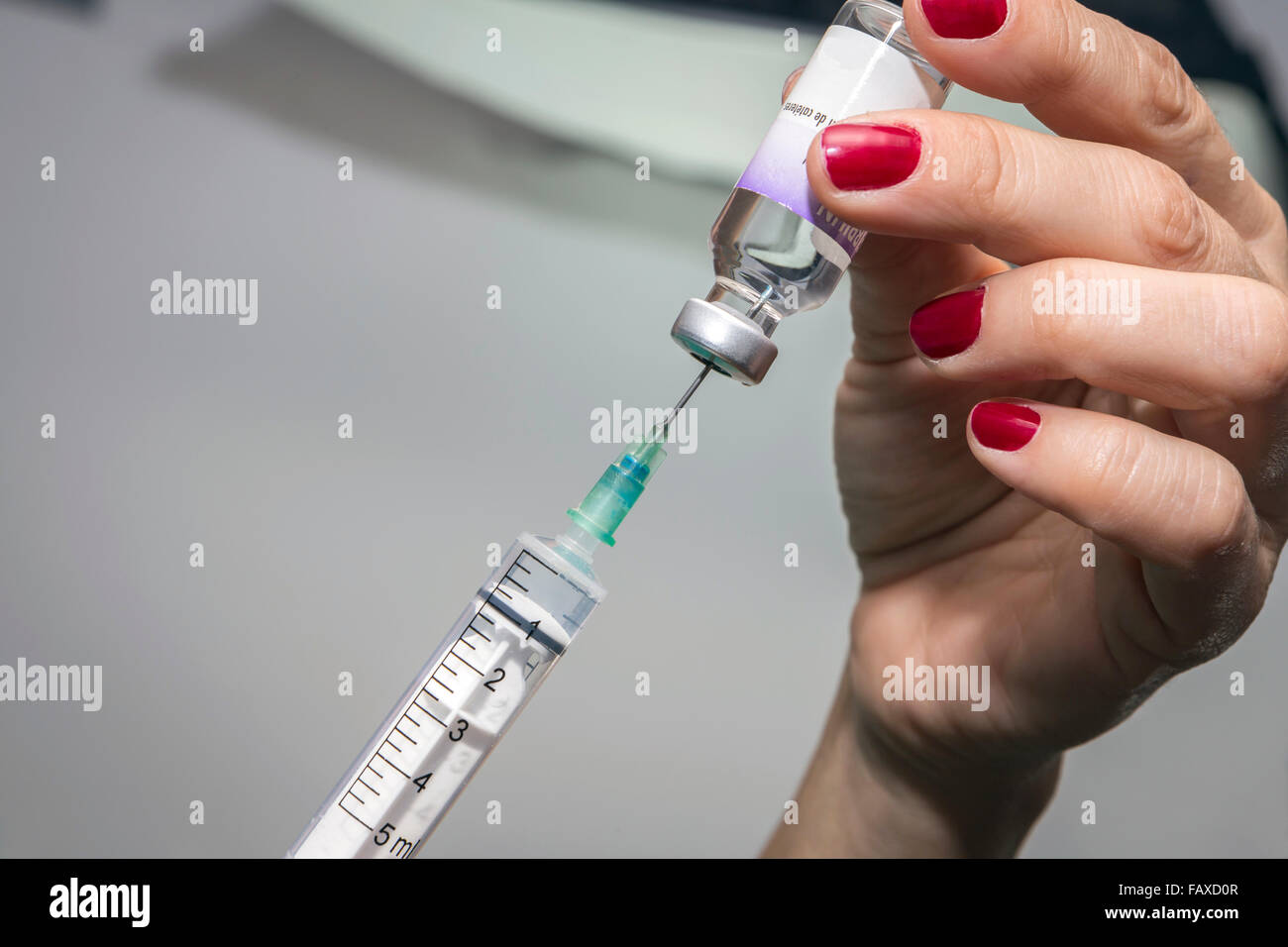 Women with nails painted with red sucks medication with syringe Stock ...