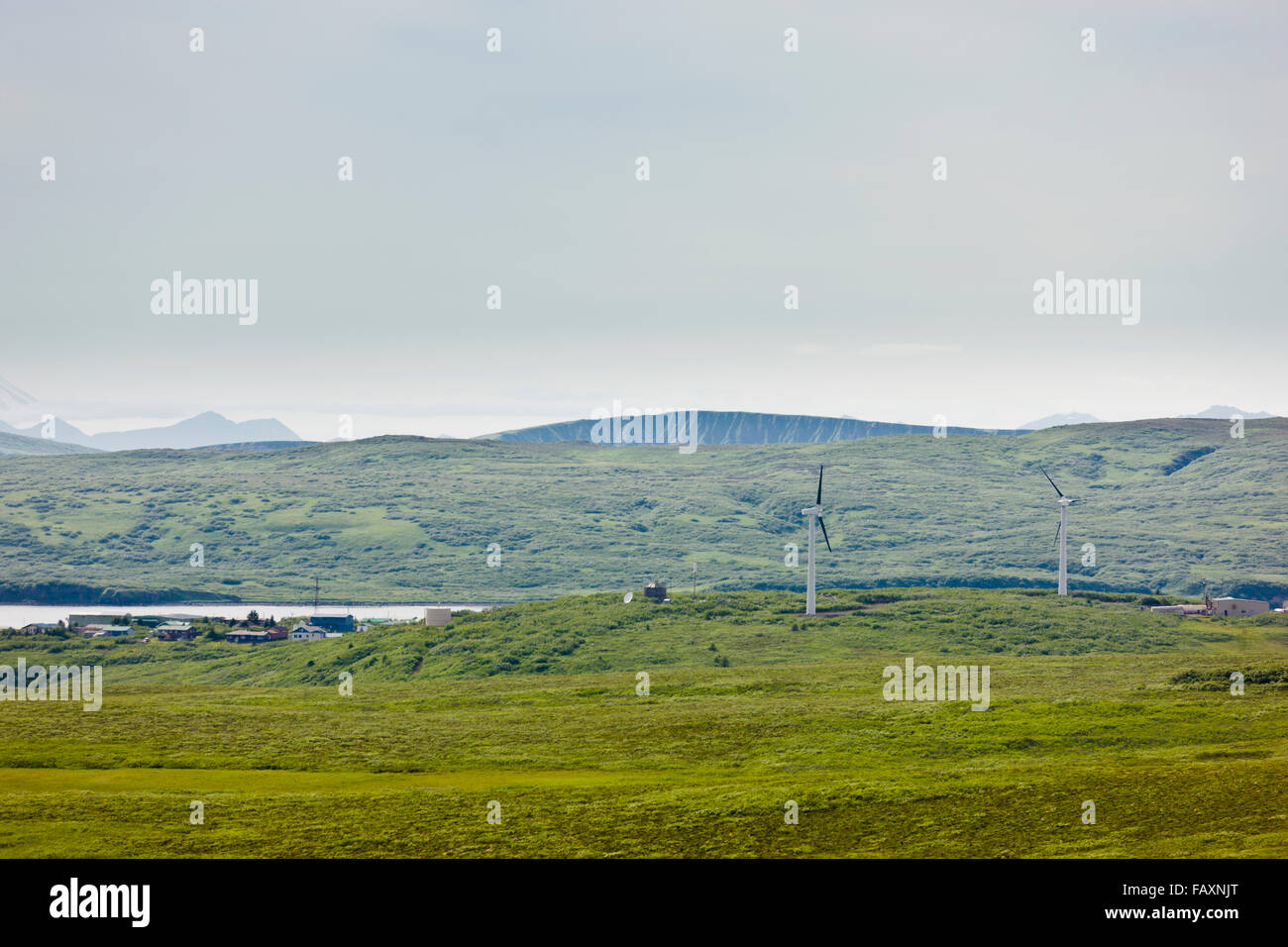 Two wind turbines sit above the city of Sand Point, Sand Point, Popof ...