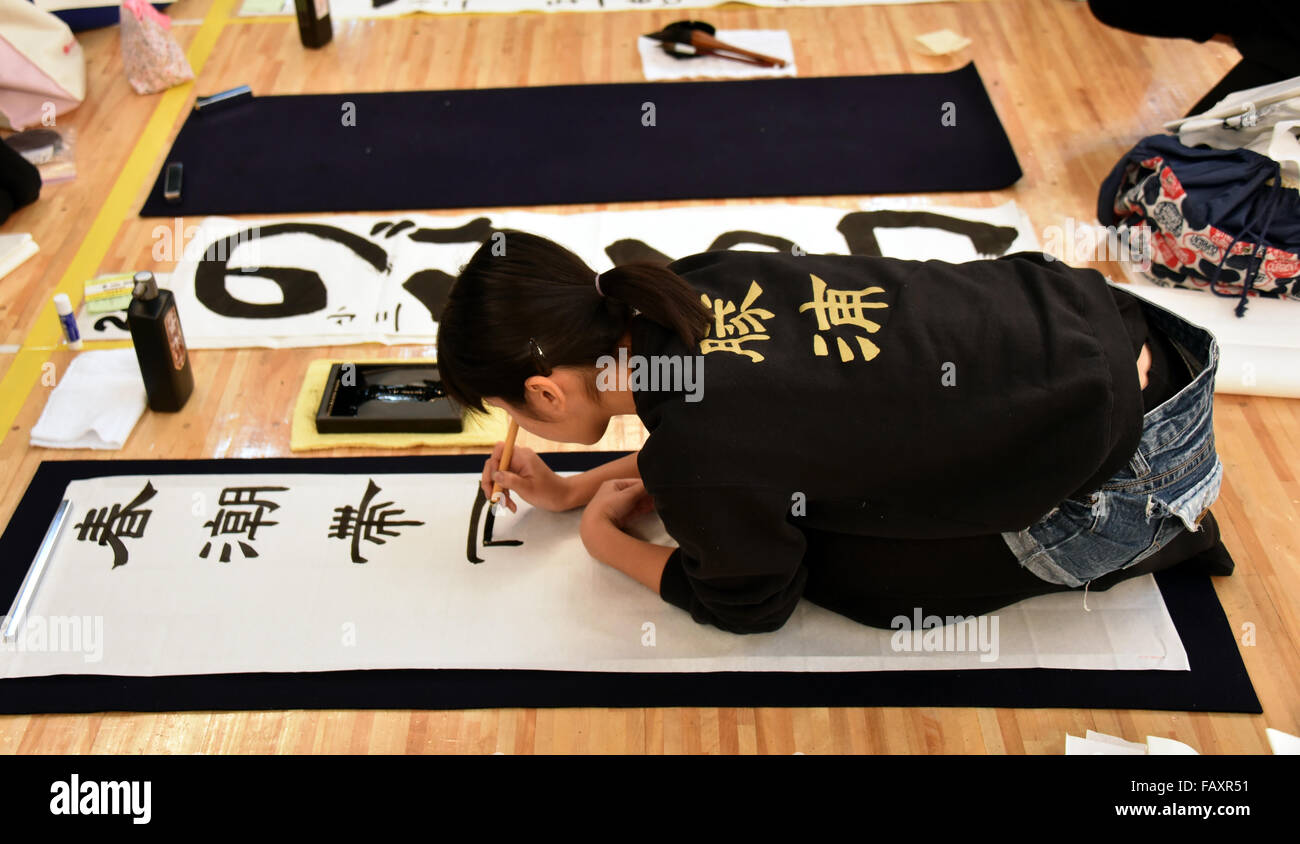 Tokyo, Japan. 5th Jan, 2016. Participants use calligraphy brushes to ...