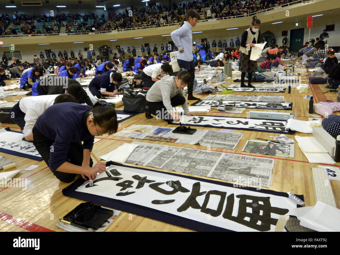 Tokyo, Japan. 5th Jan, 2016. Participants use calligraphy brushes to ...