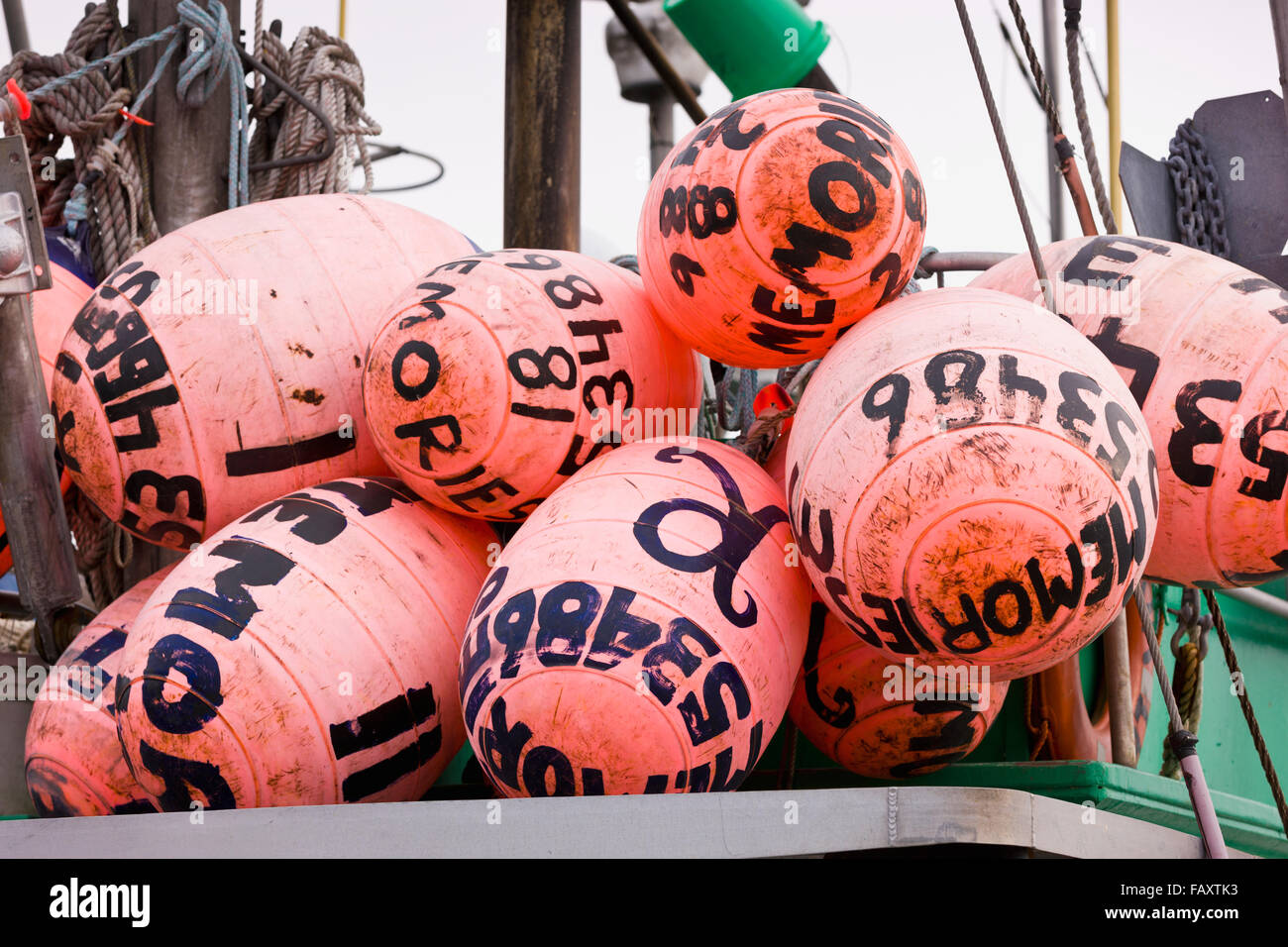 Numbered buoys piled on a fishing boat, Sand Point, Southwestern Alaska ...