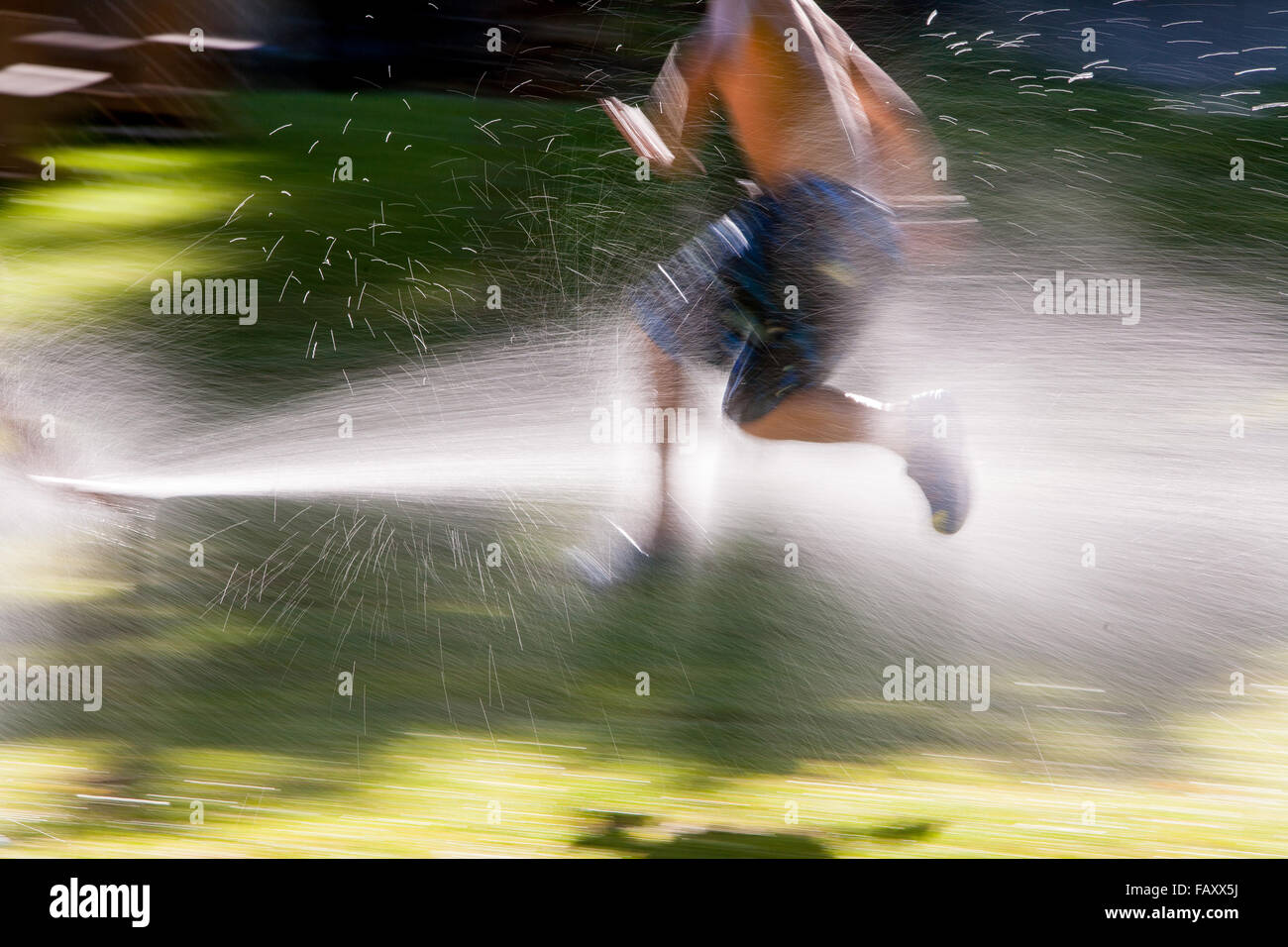 Running through the sprinkler hi-res stock photography and images - Alamy