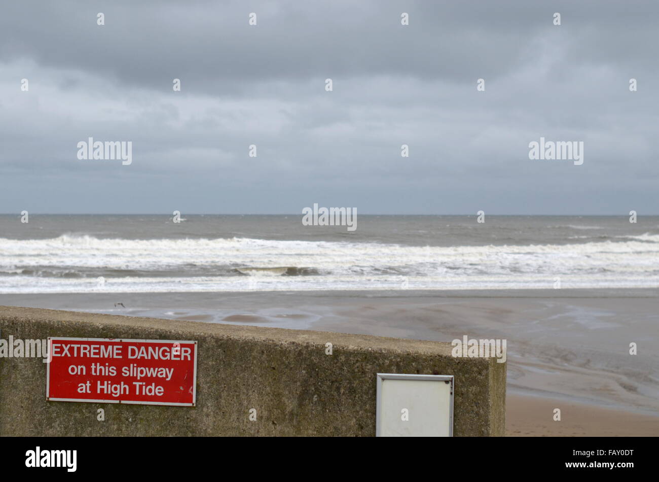 Red warning sign beach england hi-res stock photography and images - Alamy