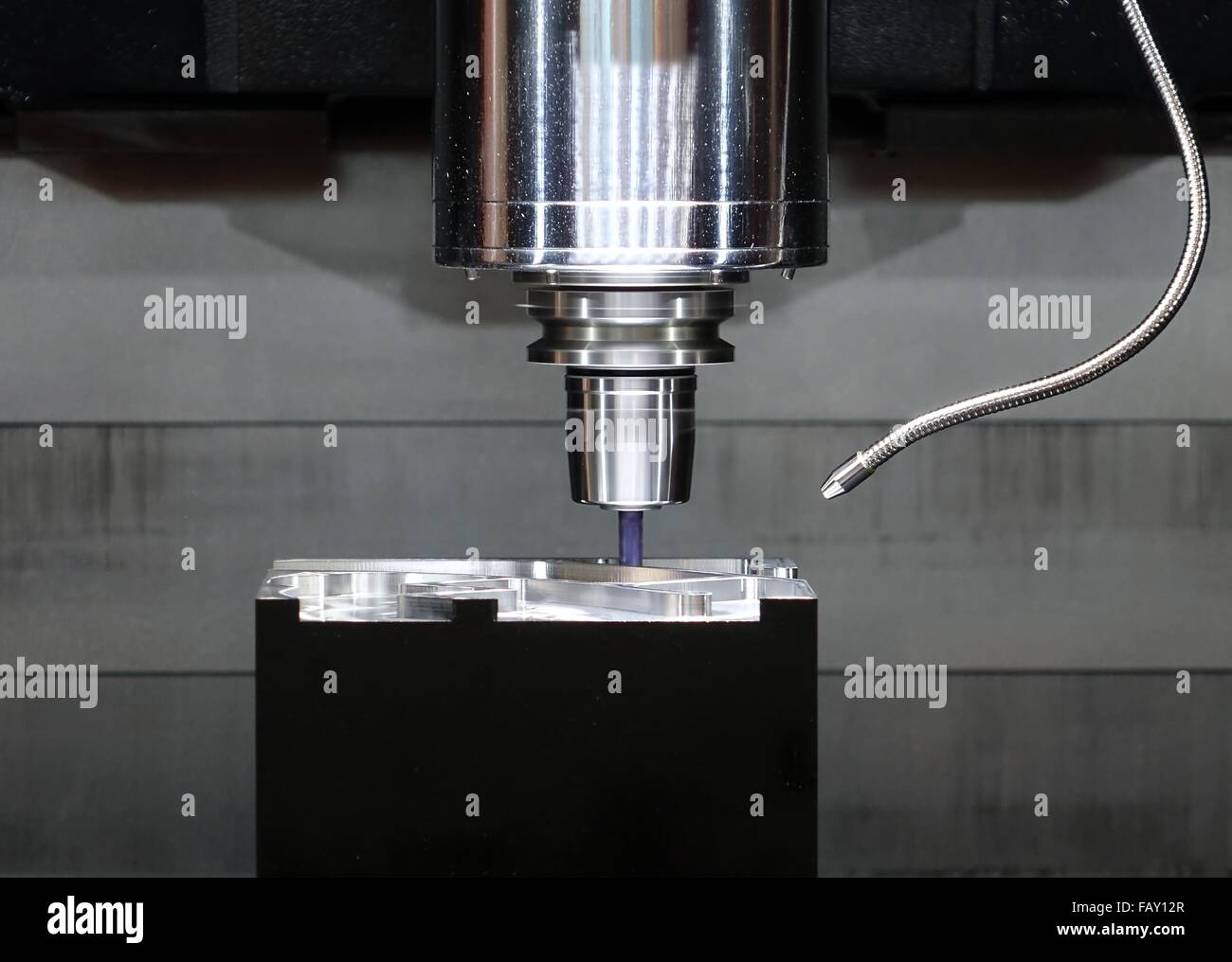 A high precision automated routing tool in operation on a piece of ...