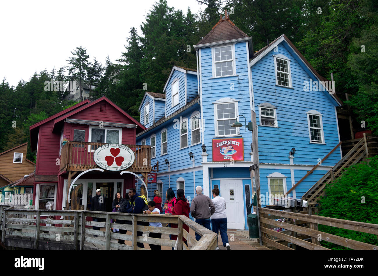 Tourists enjoy a visit to the boardwalk on Creek Street, Ketchikan ...