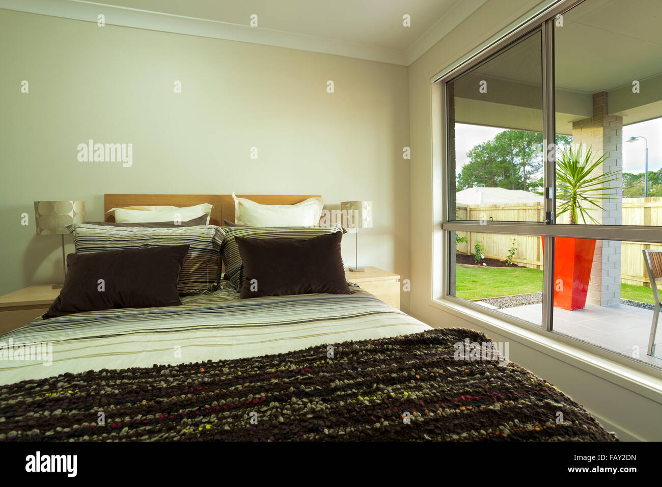 Stylish double bedroom in Australian townhouse Stock Photo - Alamy