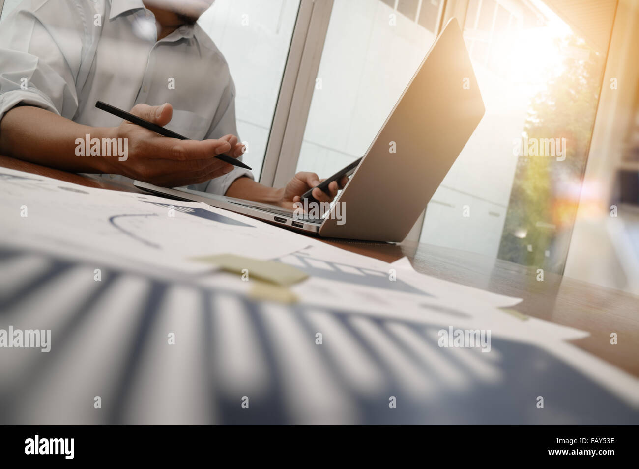 business man hand working on laptop computer with digital layer ...