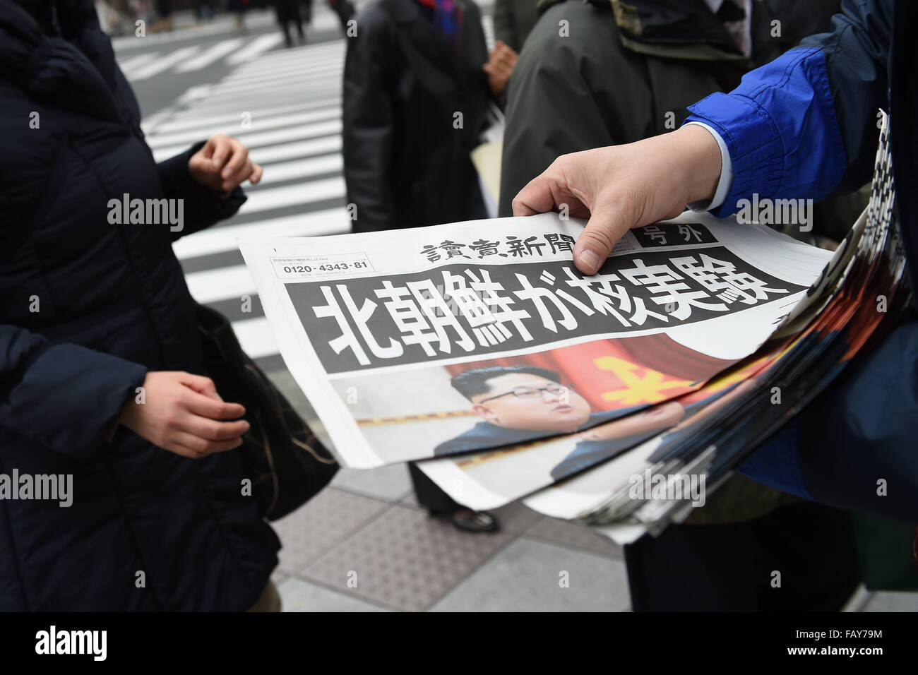Tokyo, Japan. 6th Jan, 2015. A passerby picks up a special edition ...