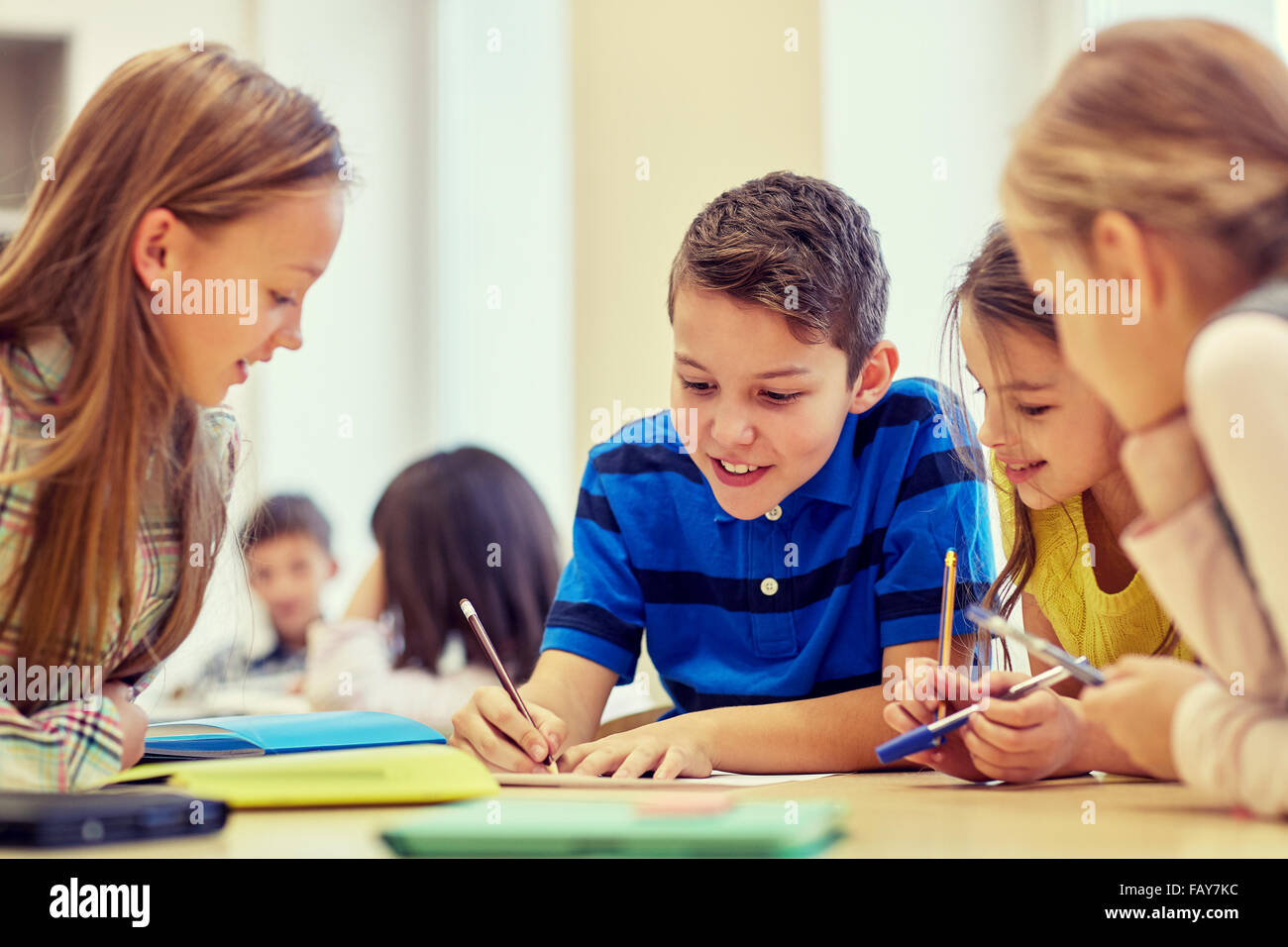group of students talking and writing at school Stock Photo - Alamy