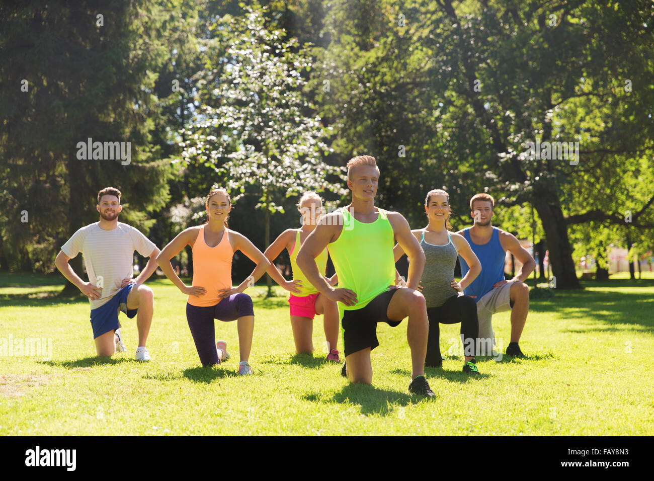 group of friends or sportsmen exercising outdoors Stock Photo - Alamy