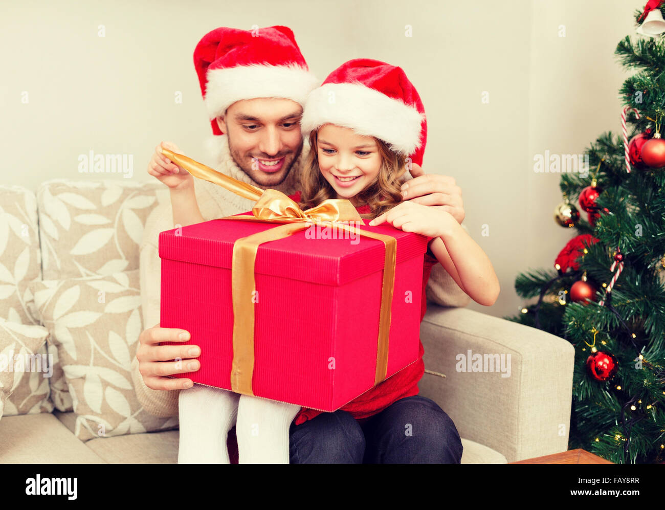smiling father and daughter opening gift box Stock Photo - Alamy