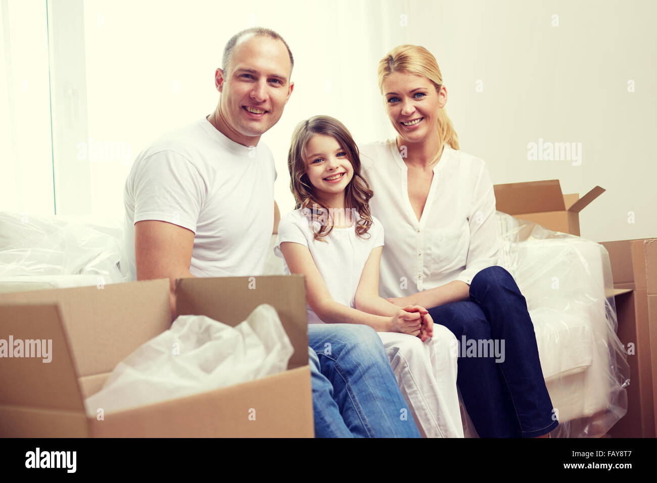happy family with boxes moving to new home Stock Photo - Alamy