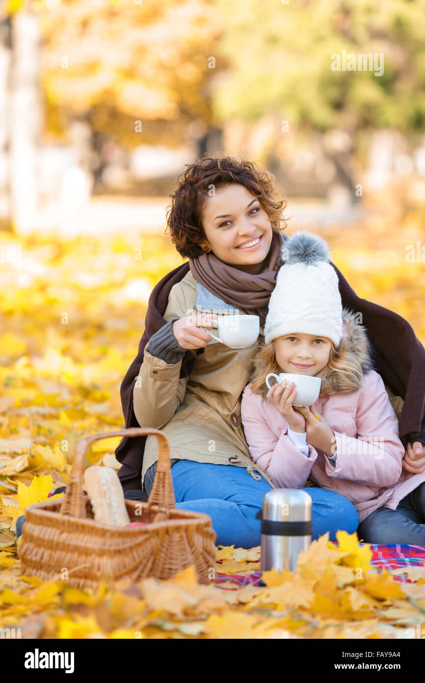 Happy mother and daughter drinking tea Stock Photo - Alamy