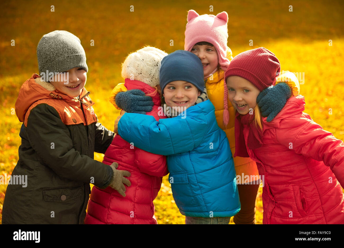 group of happy children hugging in autumn park Stock Photo - Alamy