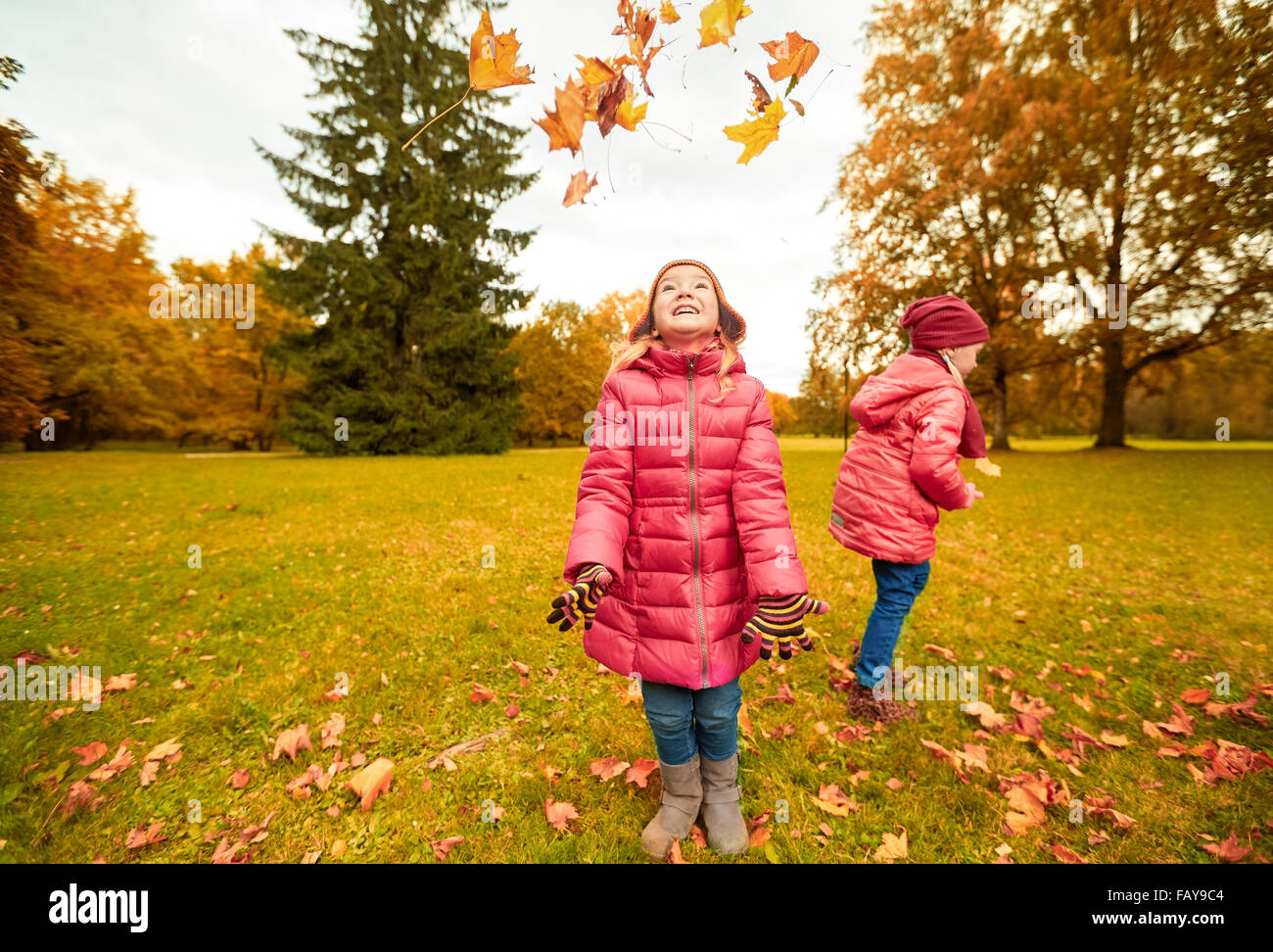 happy children playing with autumn leaves in park Stock Photo - Alamy