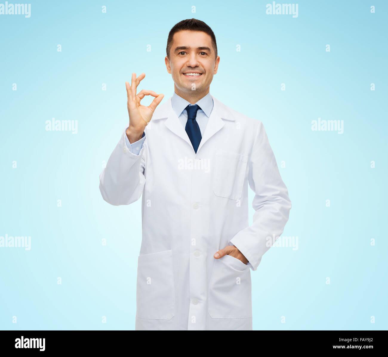 smiling doctor in white coat showing ok hand sign Stock Photo - Alamy