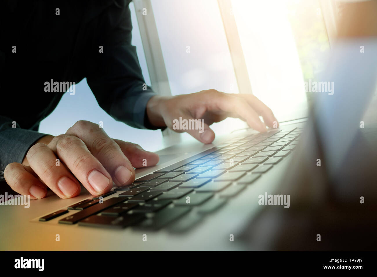 Close up of business man hand working on blank screen laptop computer ...