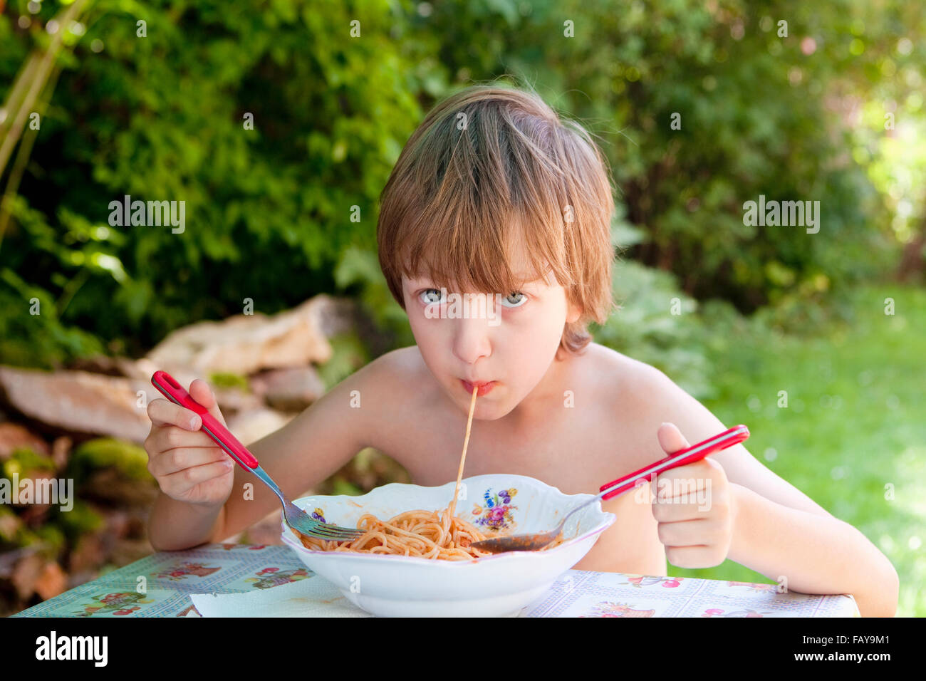 Boy with Blond Hair Eating Pasta Outdoor Stock Photo - Alamy