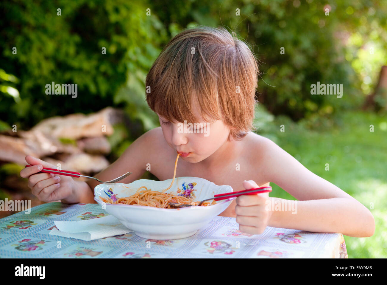 Boy with Blond Hair Eating Pasta Outdoor Stock Photo - Alamy