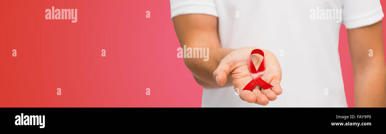 hand with red aids or hiv awareness ribbon Stock Photo - Alamy