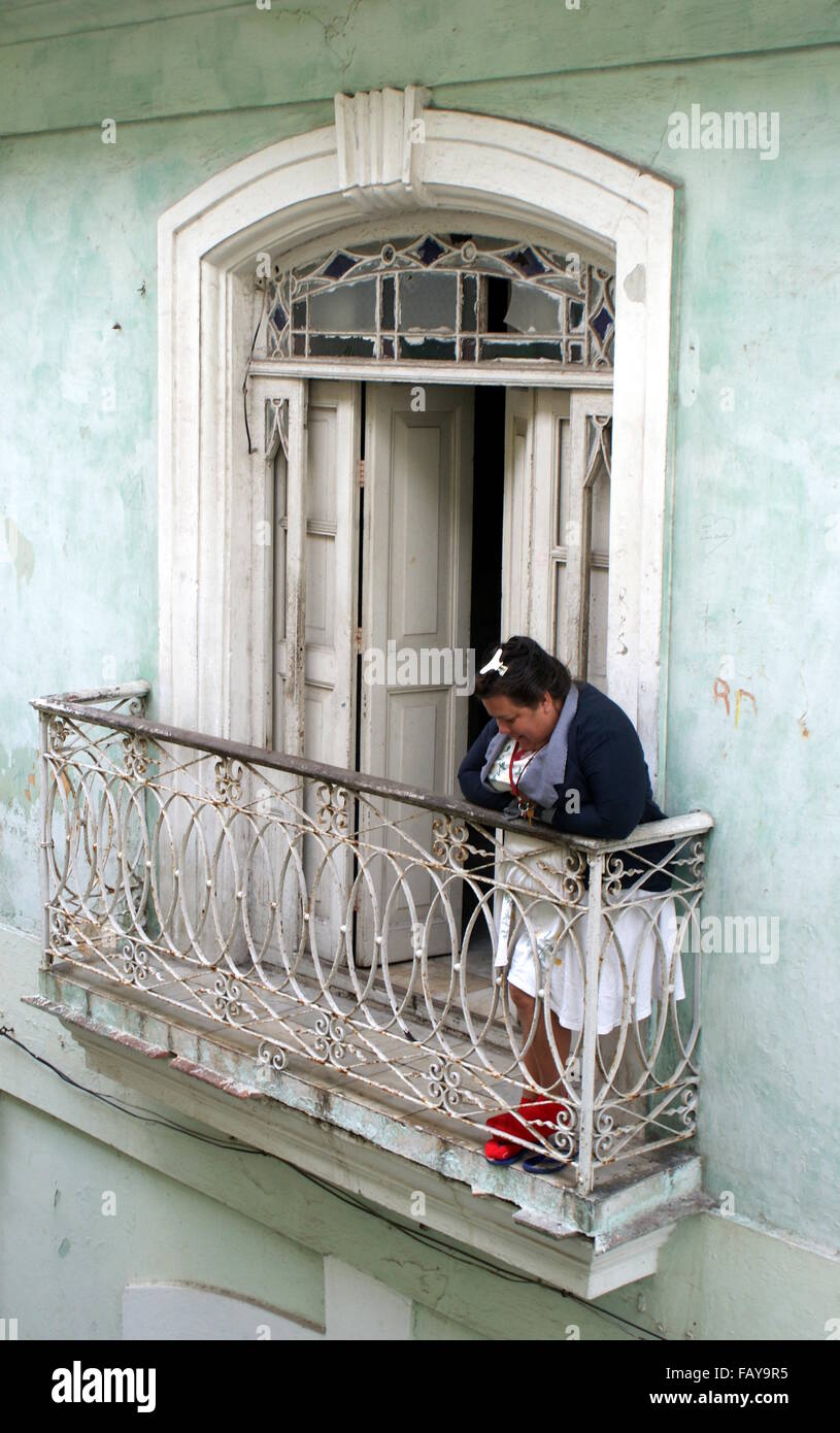 Woman looking down from balcony hi-res stock photography and images - Alamy
