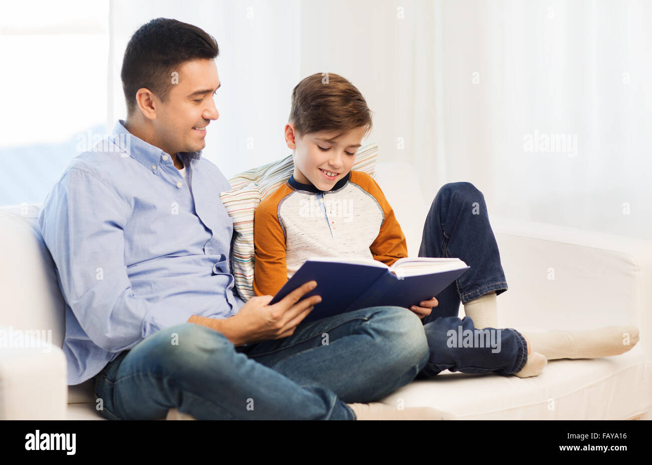 happy father and son reading book at home Stock Photo - Alamy