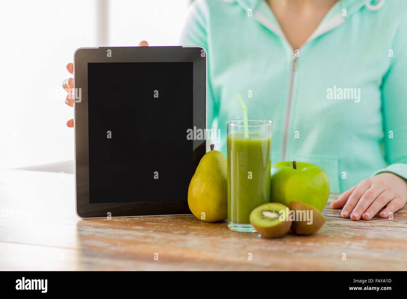 close up of woman hands tablet pc and fruit juice Stock Photo - Alamy