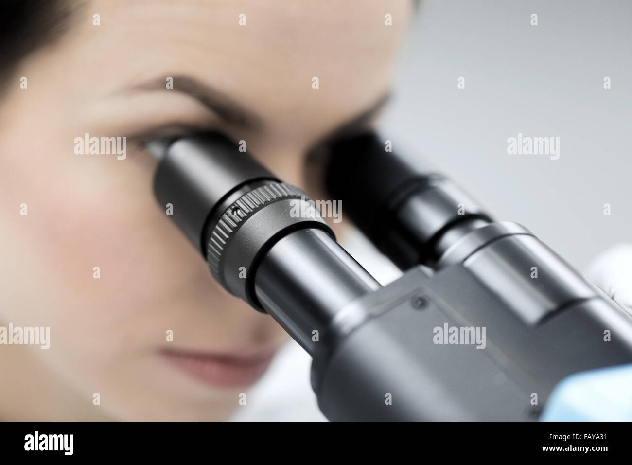 Woman looking into microscope eyepiece hi-res stock photography and ...
