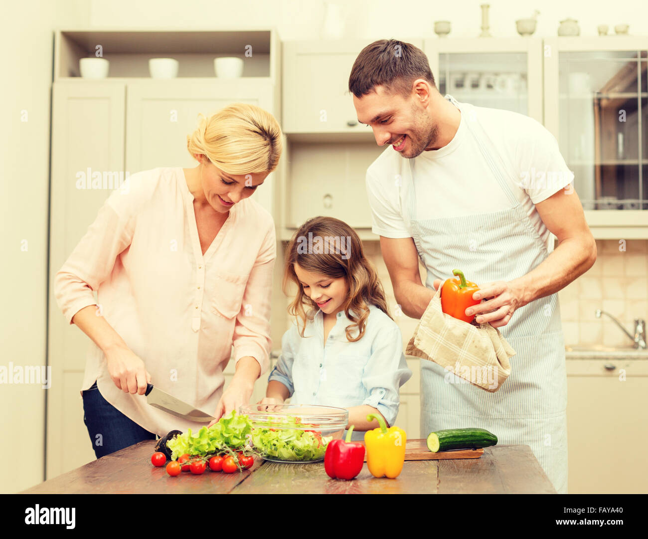happy family making dinner in kitchen Stock Photo - Alamy