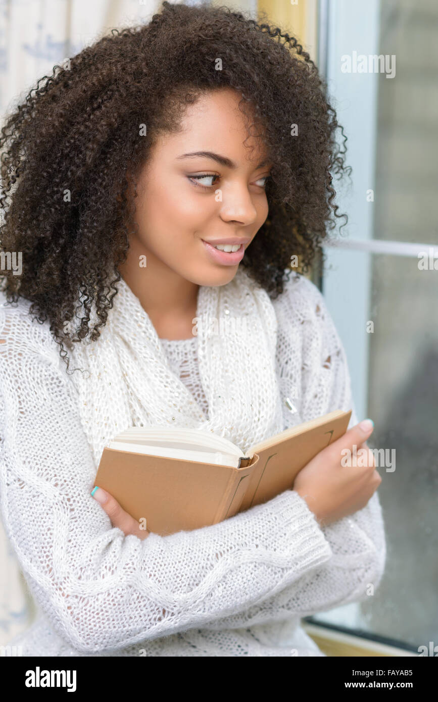 Pleasant girl enjoying reading book Stock Photo - Alamy