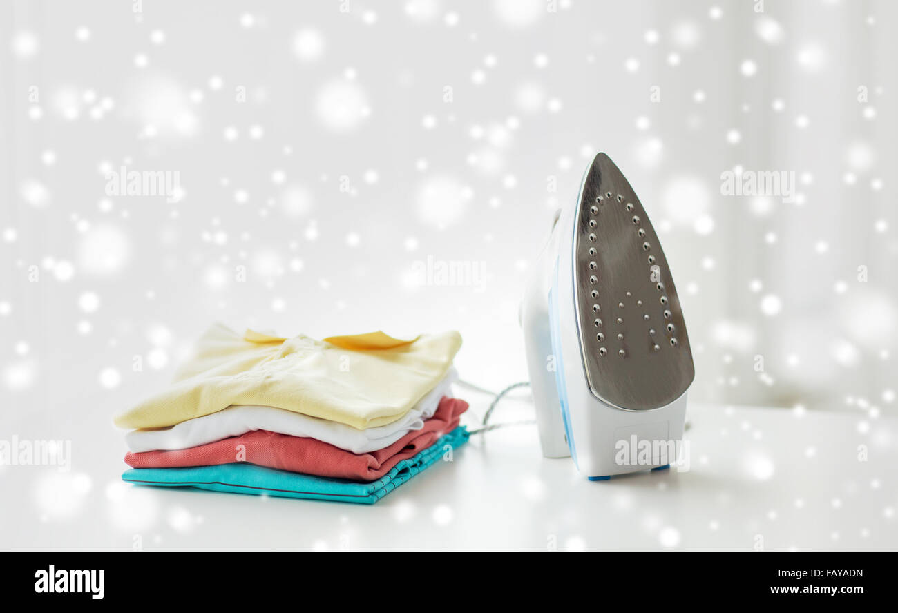 close up of iron and clothes on table at home Stock Photo - Alamy