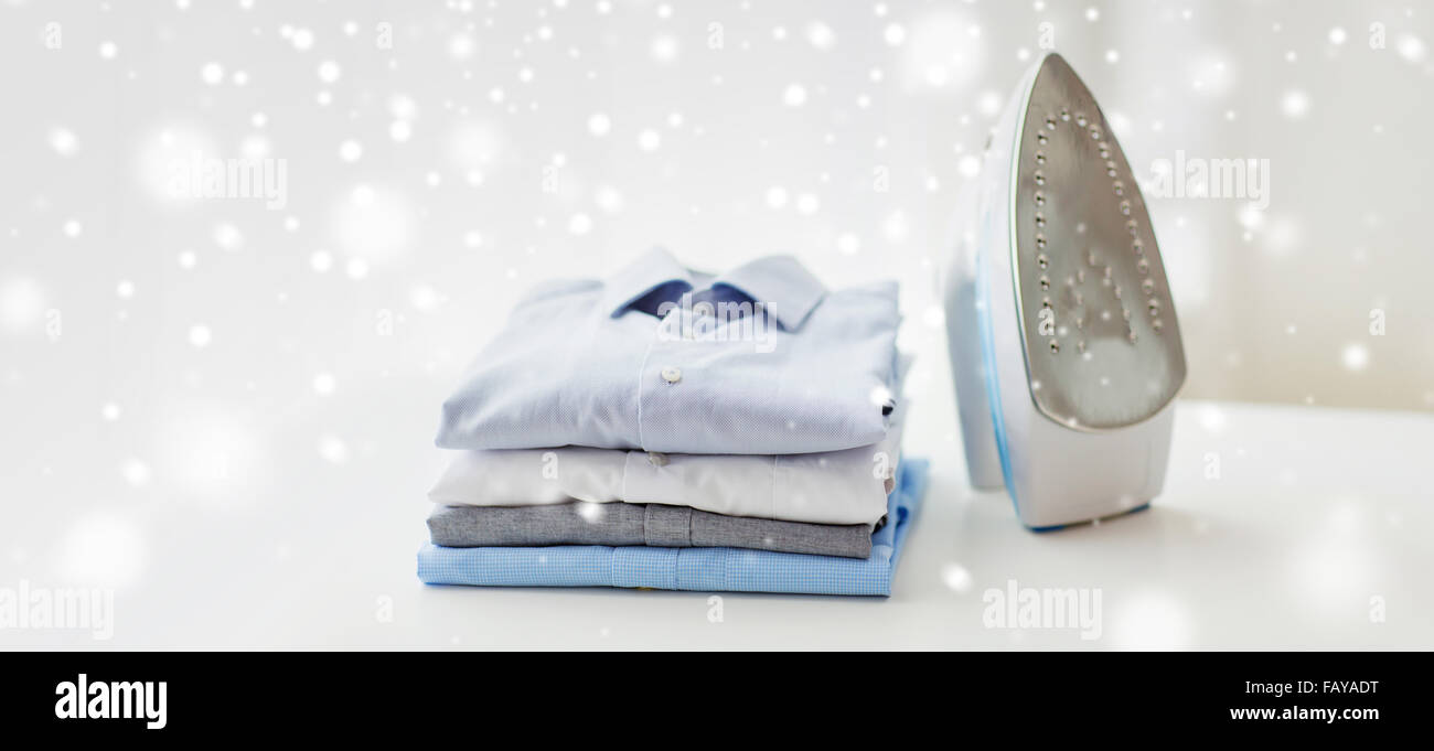 close up of iron and clothes on table at home Stock Photo - Alamy