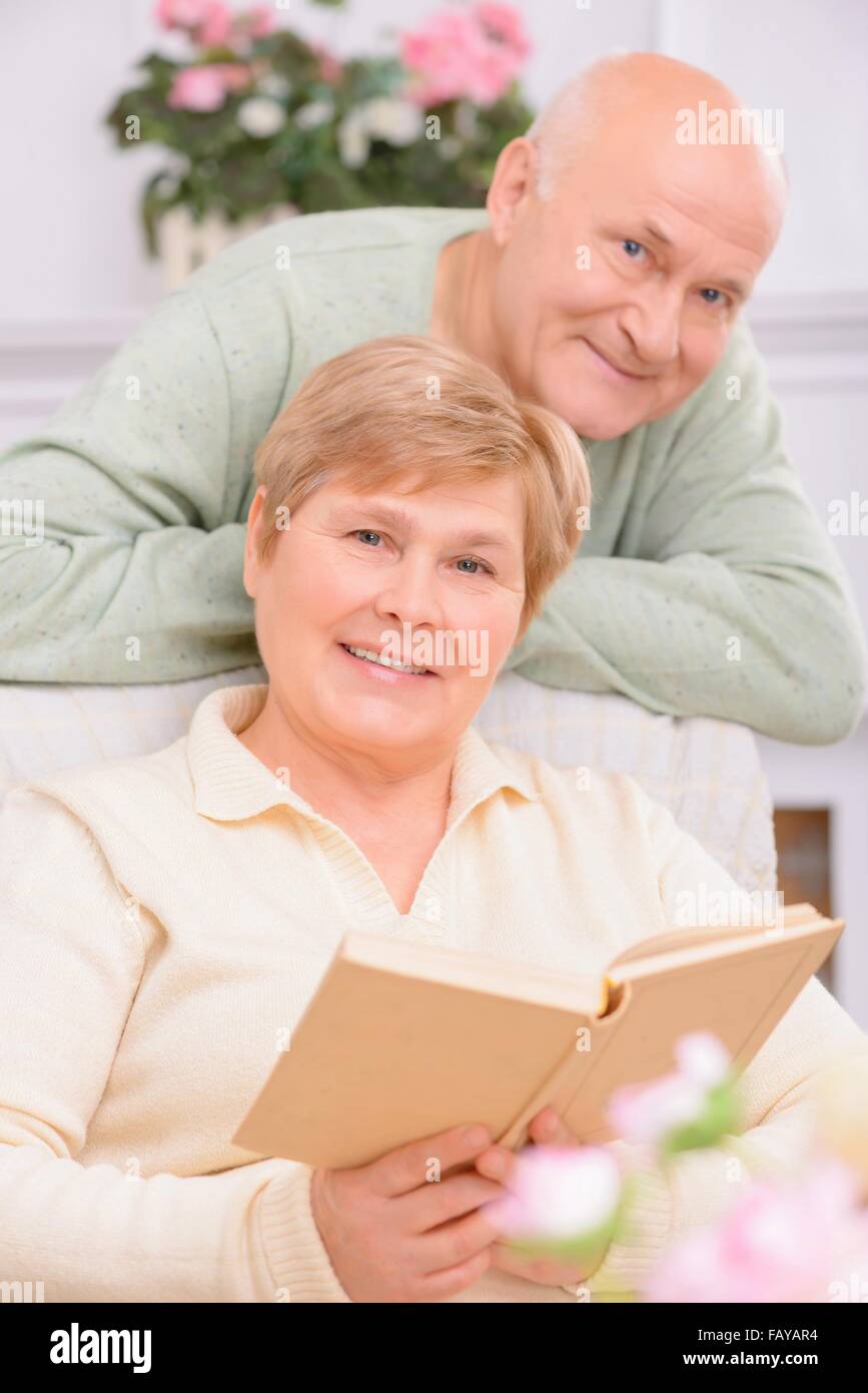 Adult couple reading book Stock Photo - Alamy