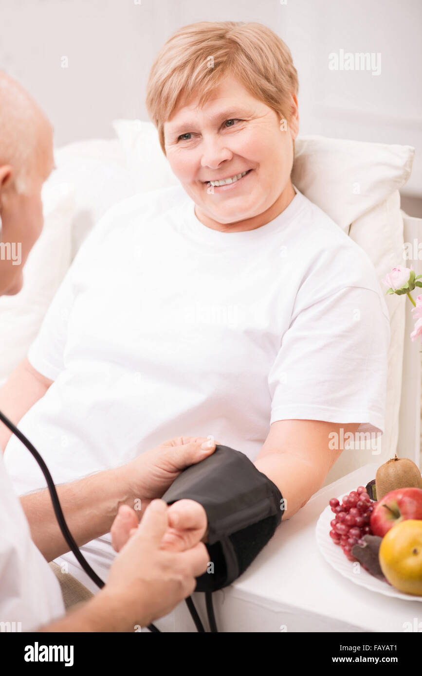Nice adult couple measuring pressure Stock Photo - Alamy