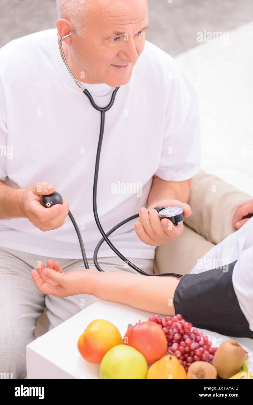 Nice adult couple measuring pressure Stock Photo - Alamy