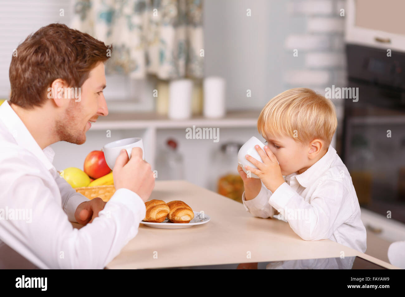 Father and son are drinking morning beverages Stock Photo - Alamy