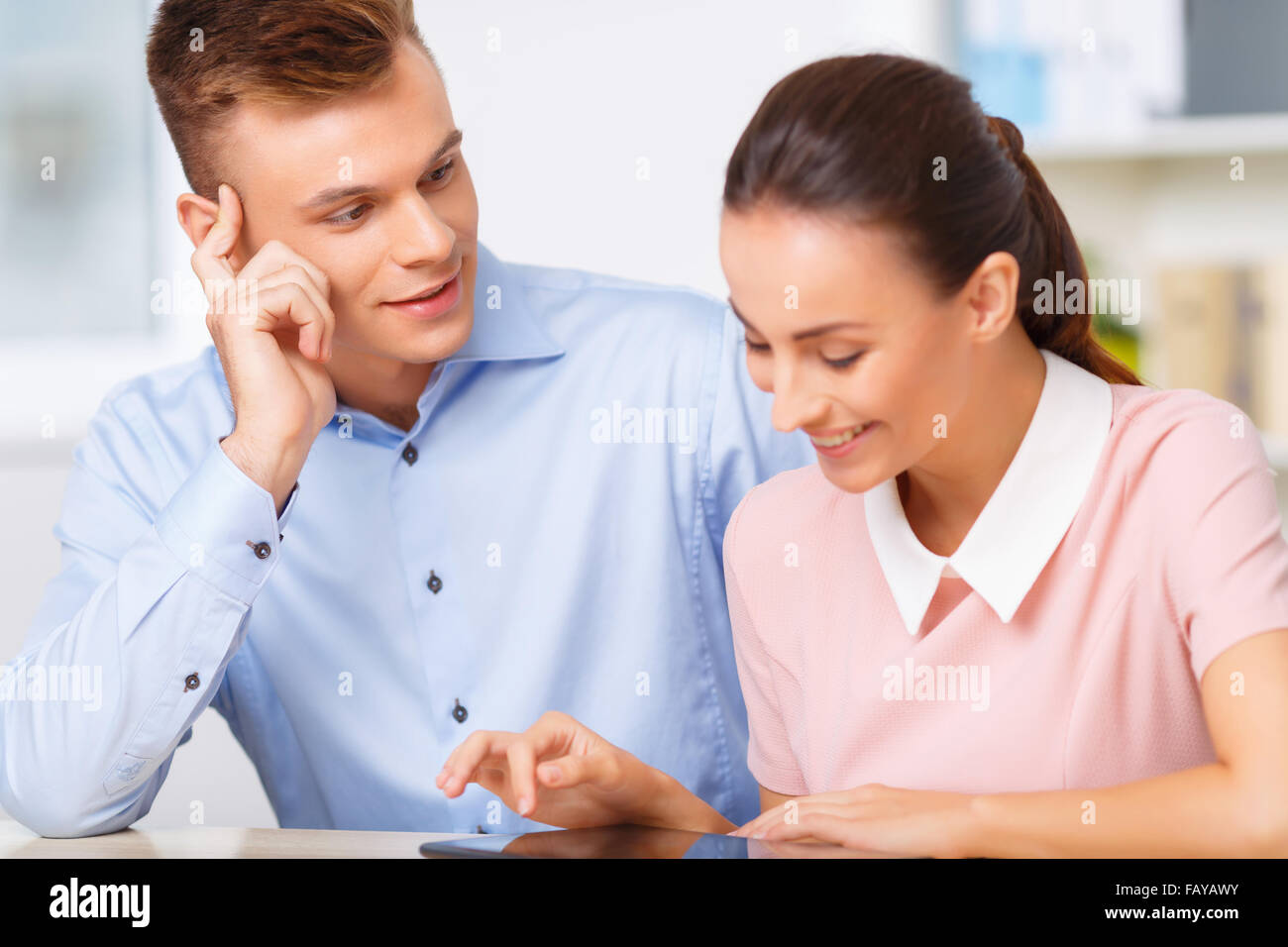 Young manager watches his sweetheart at work Stock Photo - Alamy