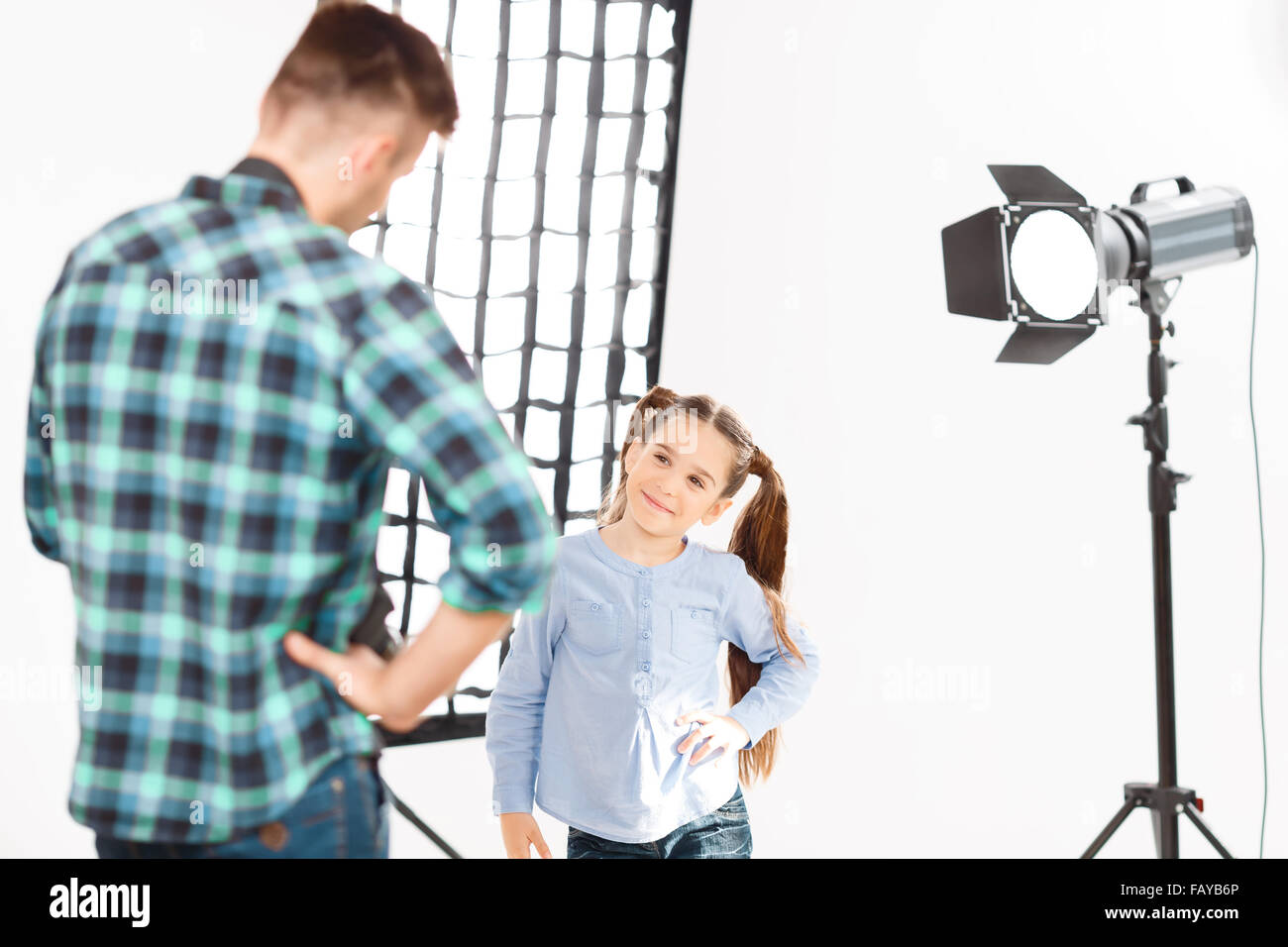Young child model copies pose of the professional Stock Photo - Alamy