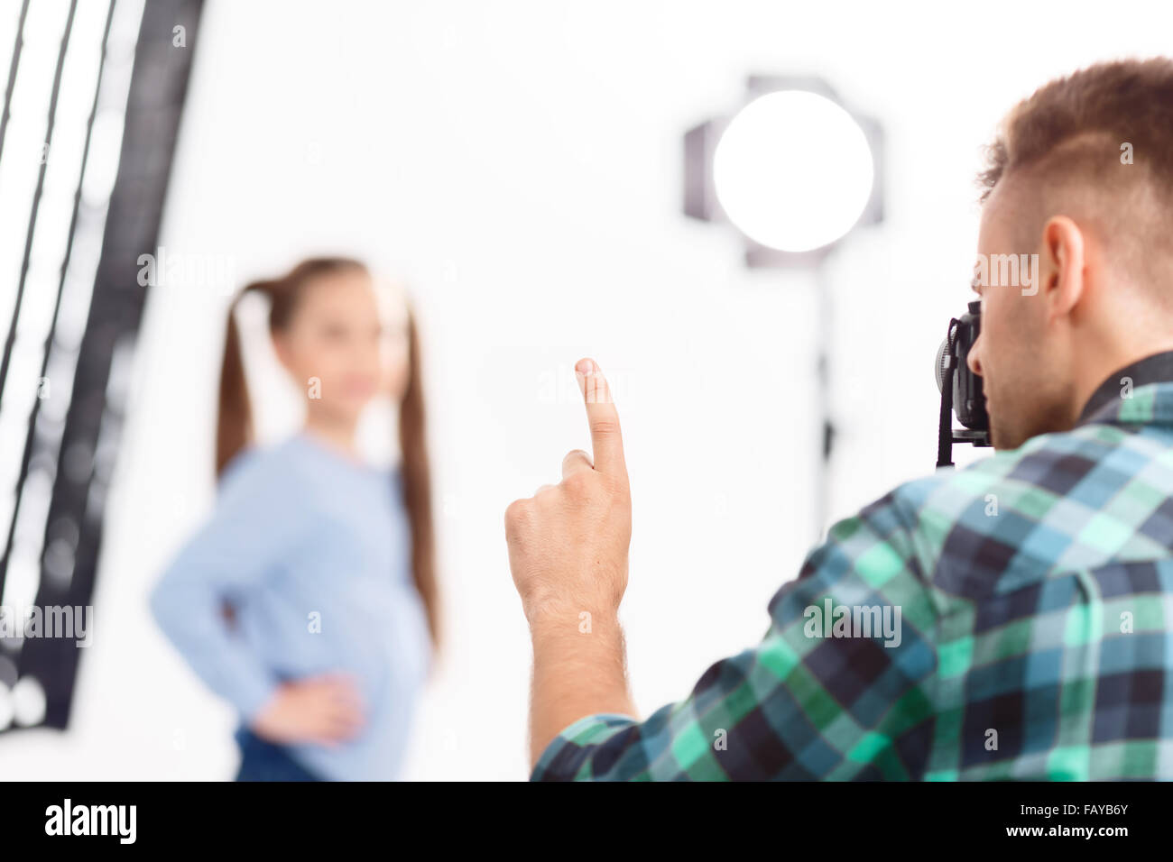 Male photographer asks a model to stand still Stock Photo - Alamy