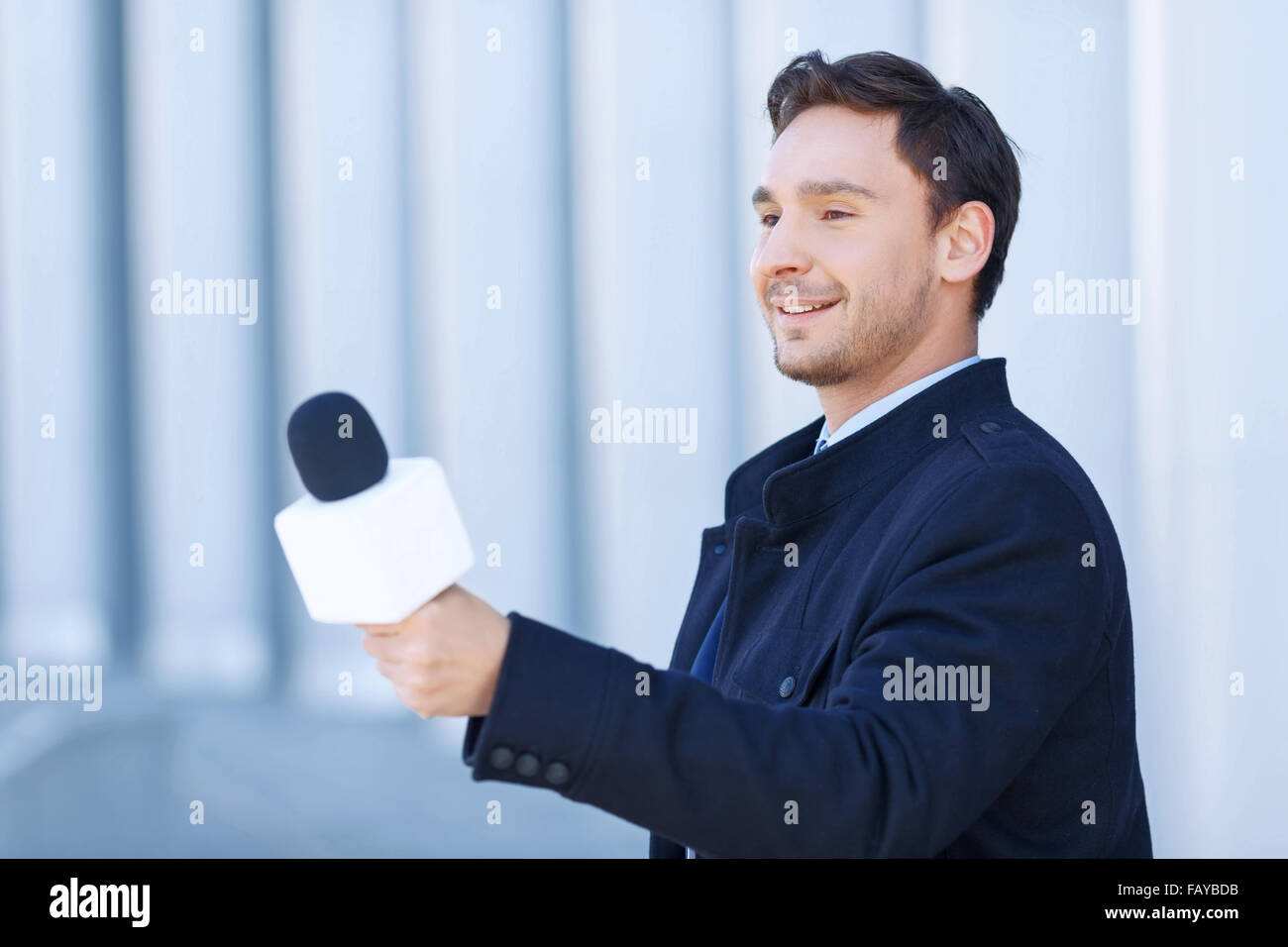 Journalist in action of taking personal interview Stock Photo - Alamy