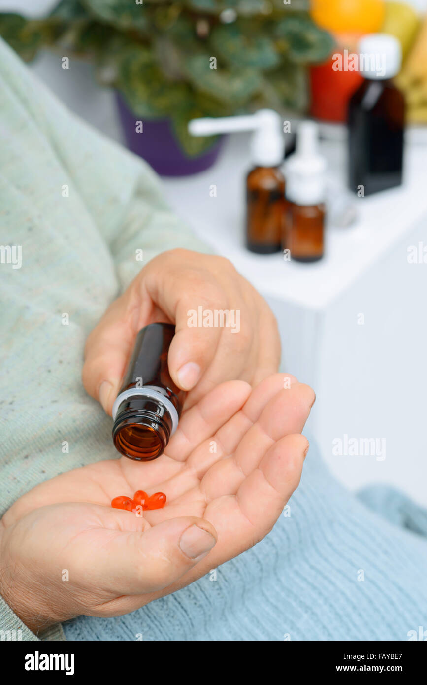 Old man takes out a few pills of remedy Stock Photo - Alamy