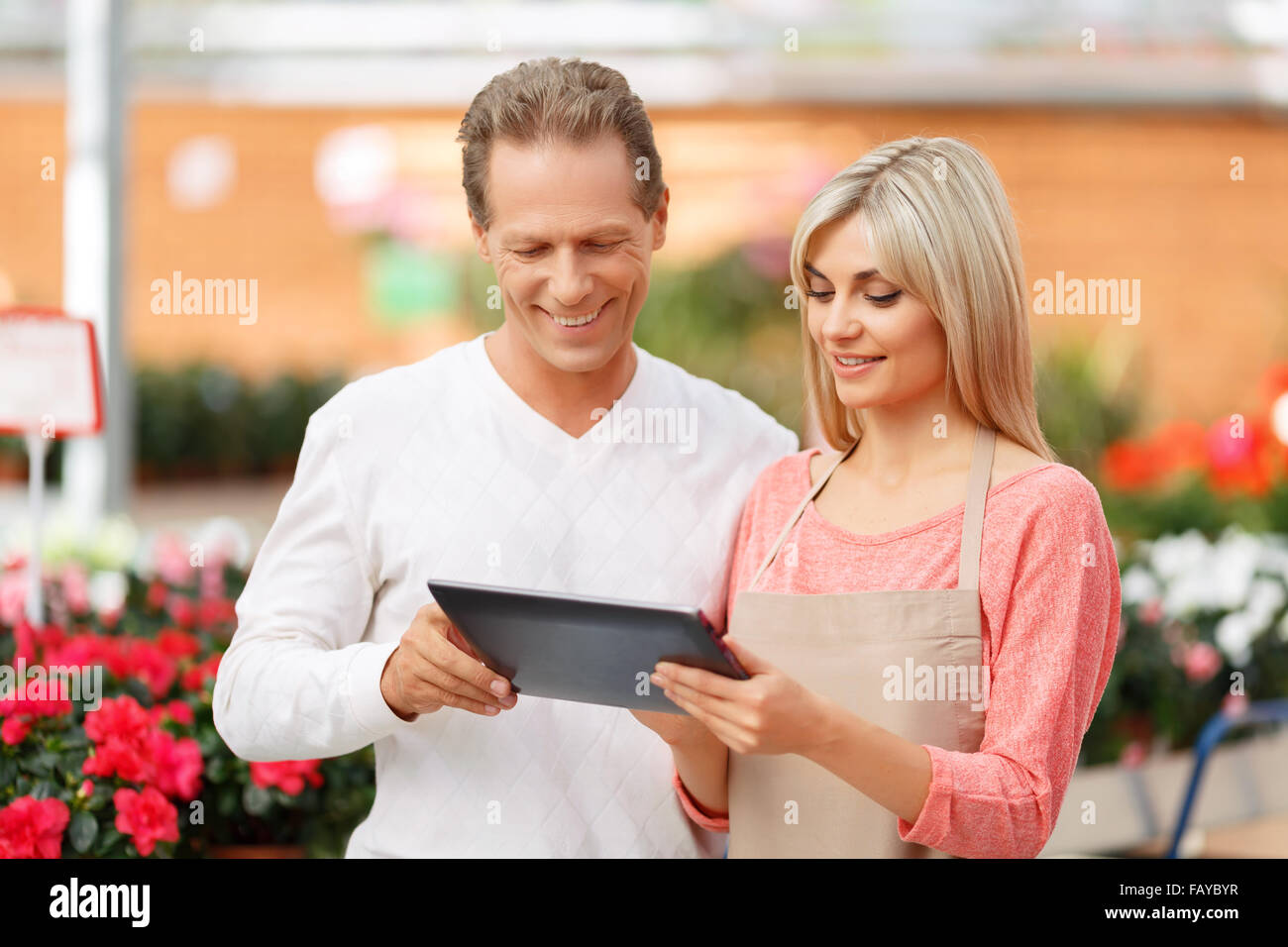 Professional florist selling flowers Stock Photo - Alamy